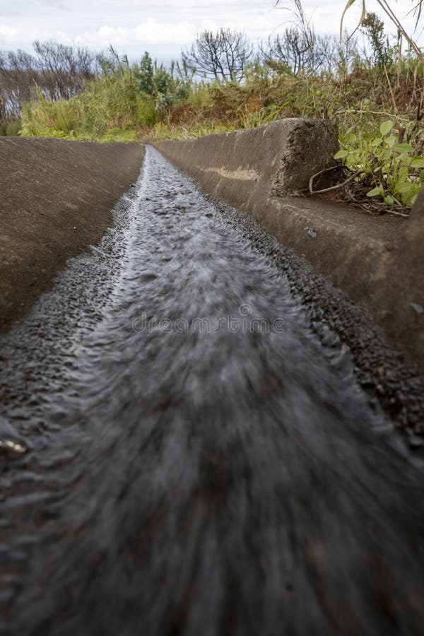 Low Angle View of Water Flowing in Concrete Roadside Gutter Stock Image ...