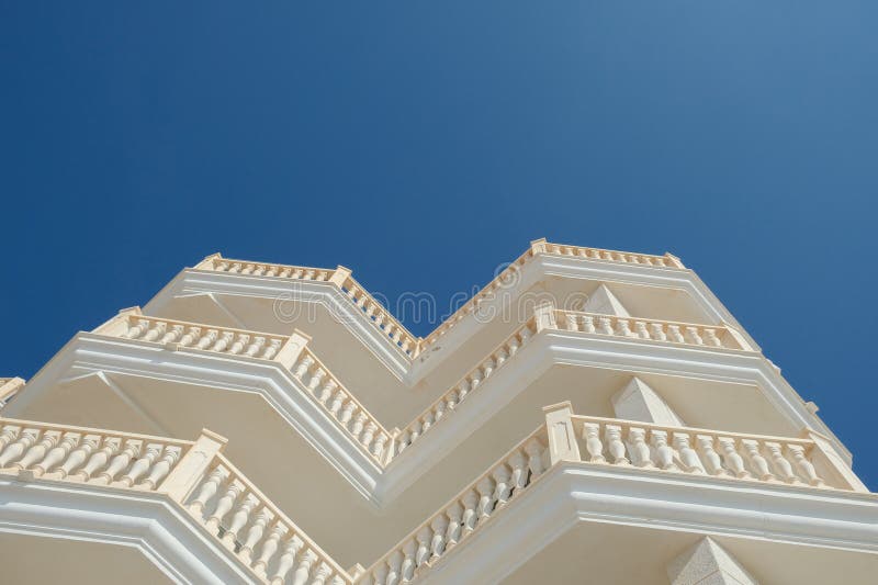Low Angle View of White Classic Building with Balcony Facing Blue Sky ...
