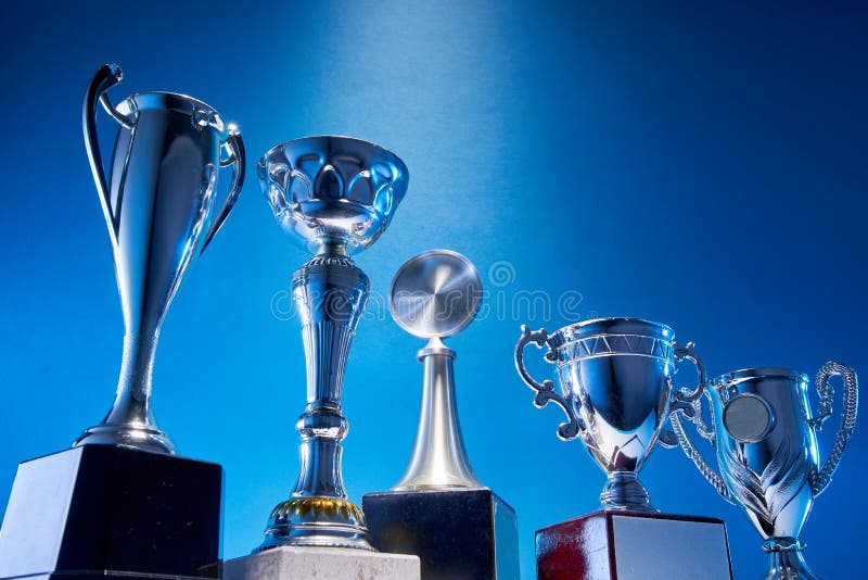 Low Angle View of Winning Trophy Against Blue Background Stock Photo ...