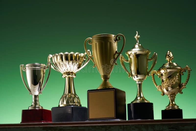 Low Angle View Group of Winning Trophy Against Green Background Stock ...