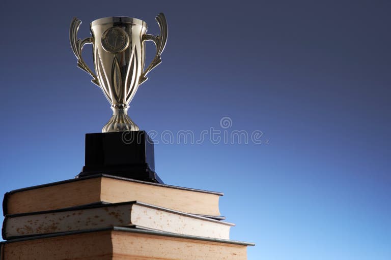 Low Angle View Winning Trophy on Stack of Books Stock Image - Image of ...