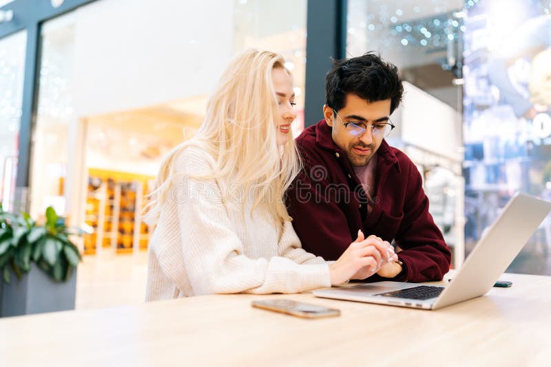 Low-angle View of Young Couple Using Typing Laptop Computer Together ...