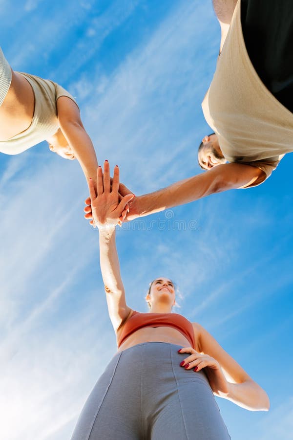 Low Angle View of Young Group of Sportive Friends in Circle Stacking ...