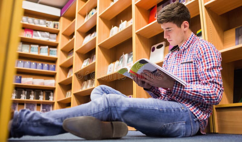 Low Angle View of Young Man Reading Book in Library Stock Image - Image ...