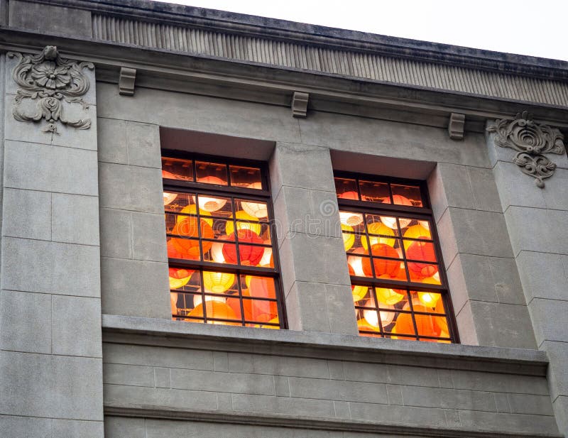 Low Angle of Windows on a Grey Building with Chinese Lanterns Inside ...