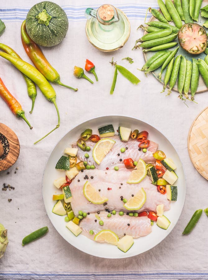 Low Carb Fish Cooking Preparation with Vegetables in White Pan on Light ...