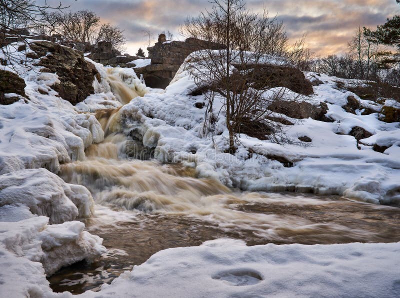 Low Exposure of Water Flowing Down the Rocks Covered in Snow. Stock ...