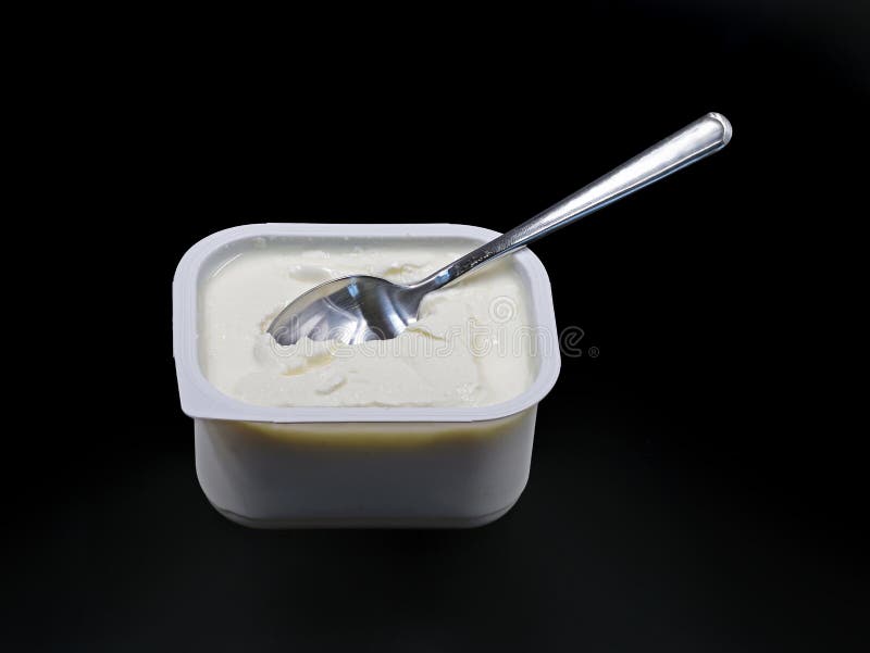 Low-fat Quark in Plastic Container with Spoon Isolated on Black ...