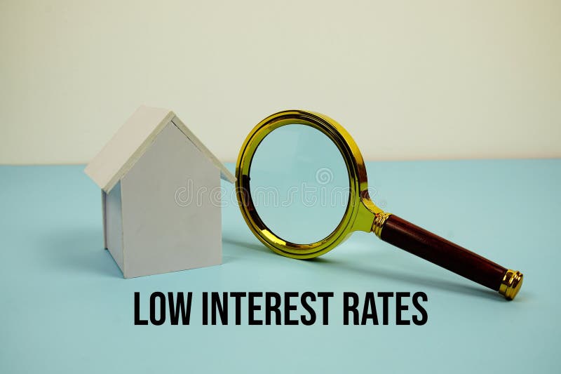 Low Interest Rates Text with White Model House and Magnifying Glass on ...