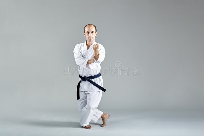 In a Low Karate Stand, an Athlete Does Formal Karate Exercises Stock ...