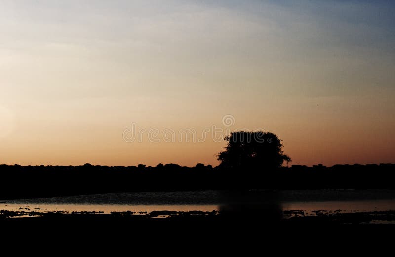 LOW KEY EFFECT on SUNSET OVER PAN of WATER Stock Photo - Image of ...