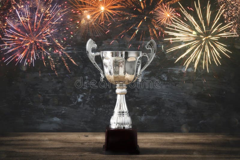 Low Key Image of Trophy Over Wooden Table and Dark Background, with ...