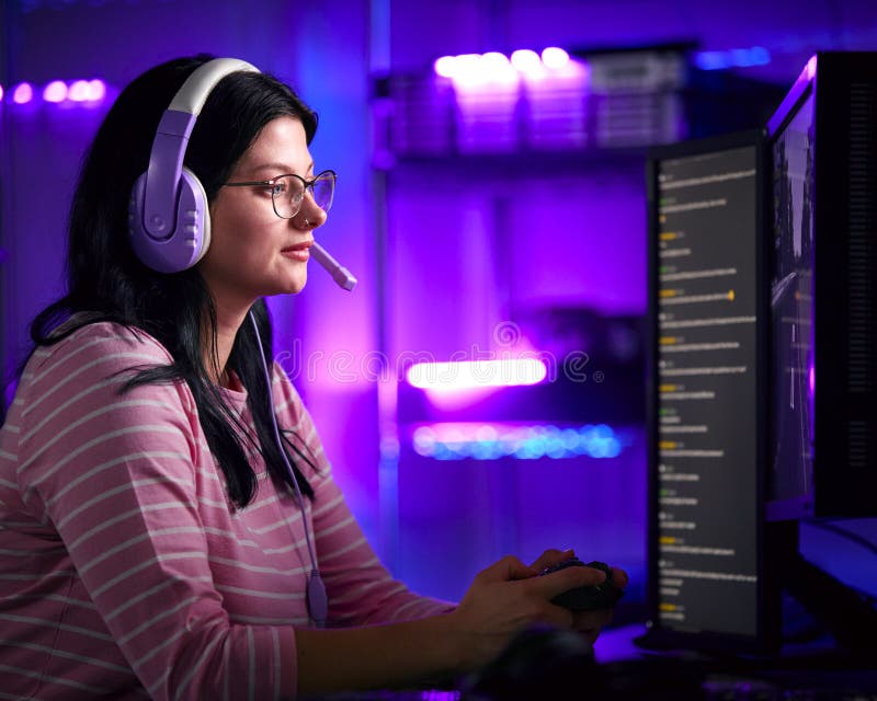 Low Key Lighting Shot of Female Gamer in Front of Computer Screens with ...