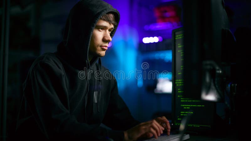 Low Key Lighting Shot of Male Computer Hacker Sitting in Front of ...