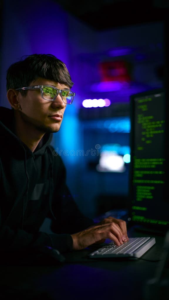 Low Key Lighting Shot of Male Computer Hacker Sitting in Front of ...