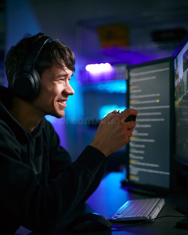 Low Key Lighting Shot of Male Gamer in Front of Computer Screens with ...