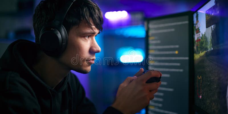 Low Key Lighting Shot of Male Gamer in Front of Computer Screens with ...