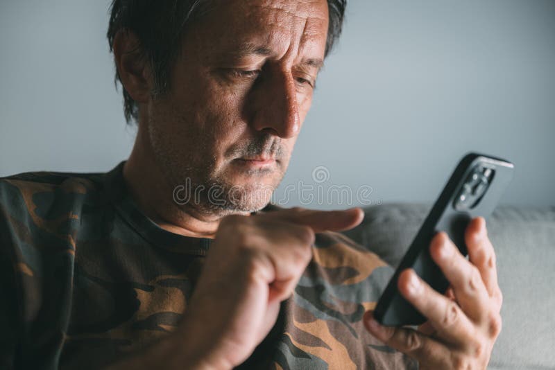 Low Key Portrait of Middle-aged Man Using Mobile Phone at Home Stock ...