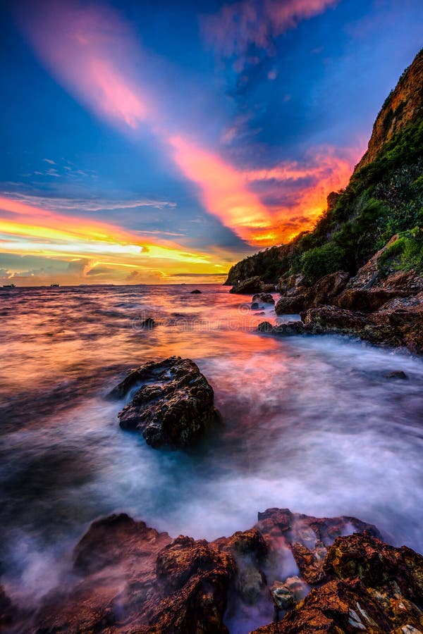 Low Light Long Exposure Scenery of Sunset on the Rocky Beach Wit Stock ...