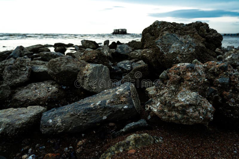 Large Pile of Rocks during the Evening Time by the Sea. Stock Photo ...