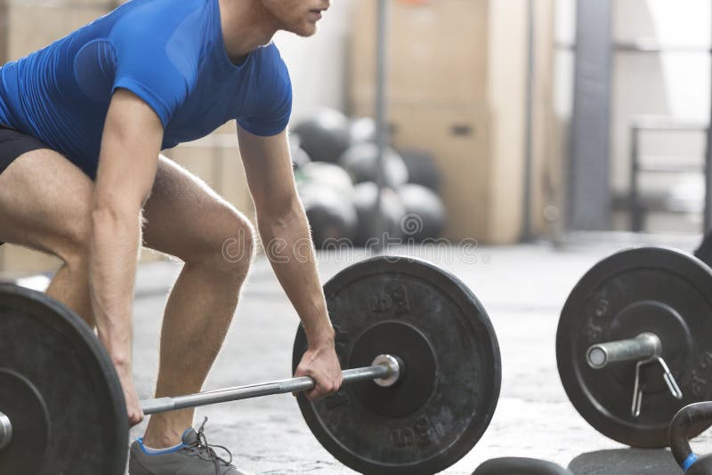 Low Section of Dedicated Man Lifting Barbell in Crossfit Gym Stock ...