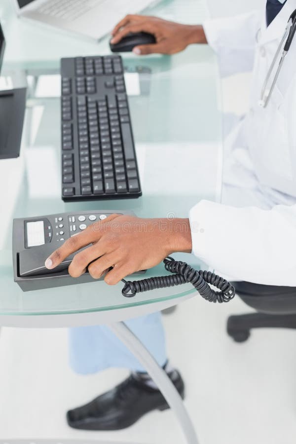 Low Section of Doctor Using Computer at Medical Office Stock Image ...