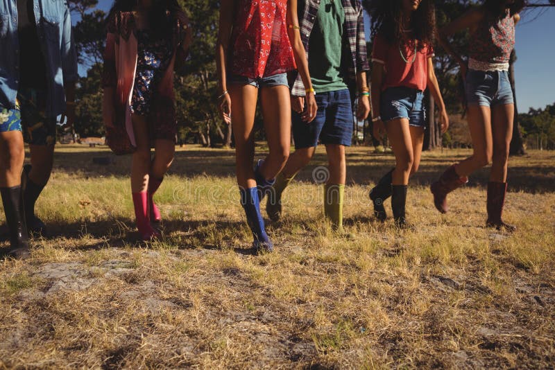 Low Section of Friends Walking on Field Stock Image - Image of leisue ...