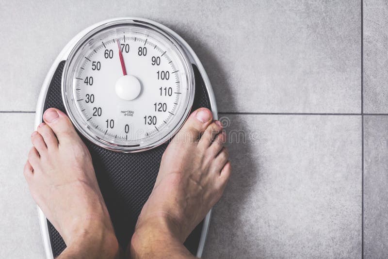 Low Section of Man Standing on Weight Scale Stock Photo - Image of ...