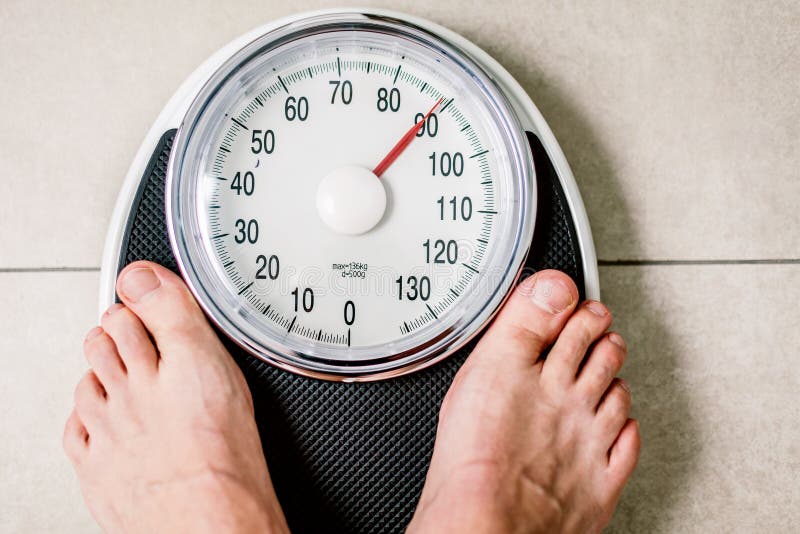 Low Section of Man Standing on Weight Scale Stock Image - Image of ...