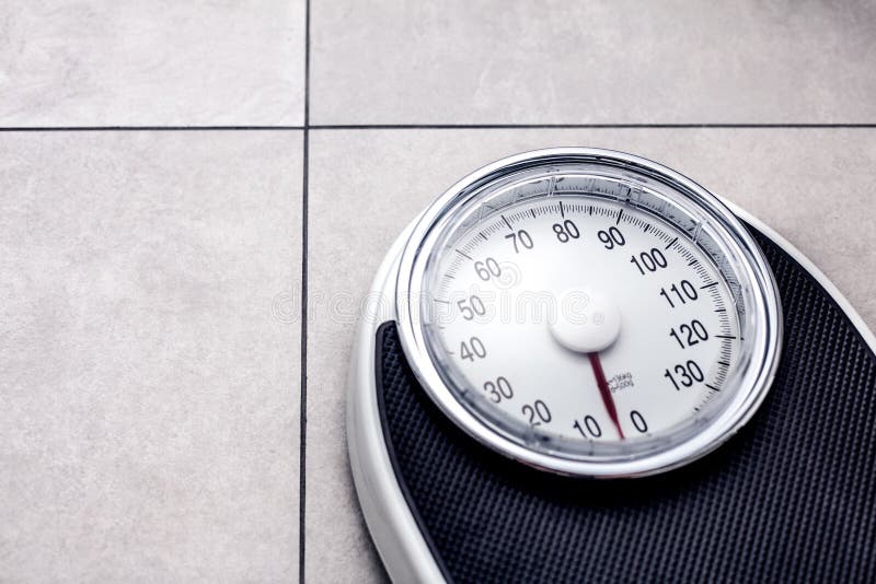 Low Section of Man Standing on Weight Scale Stock Image - Image of ...
