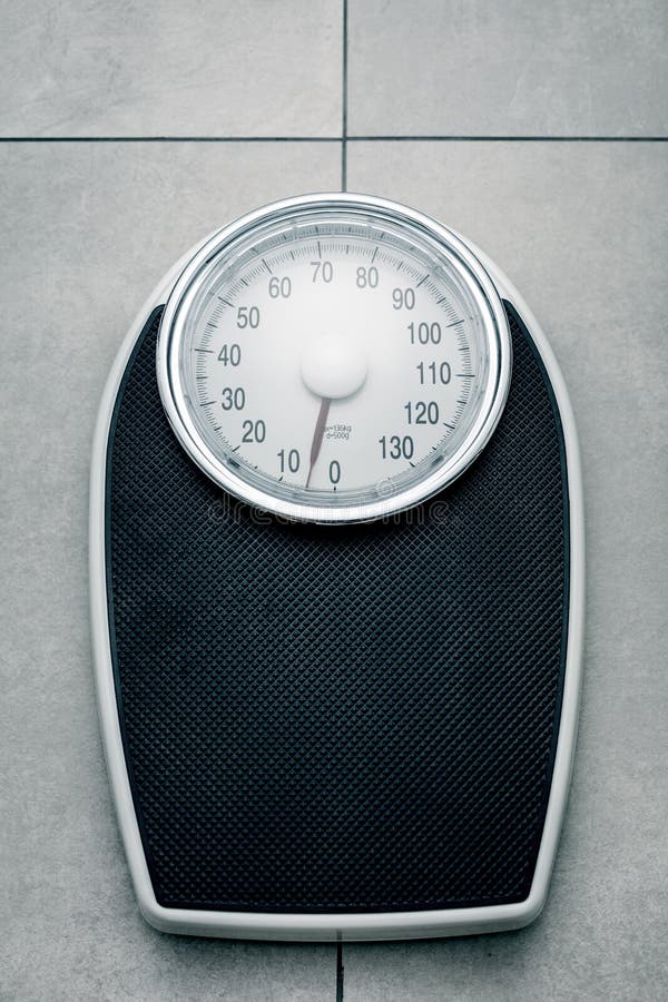 Low Section of Man Standing on Weight Scale Stock Image - Image of ...