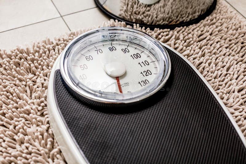 Low Section of Man Standing on Weight Scale Stock Photo - Image of feet ...