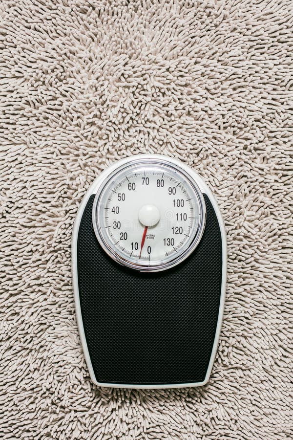Low Section of Man Standing on Weight Scale Stock Image - Image of ...