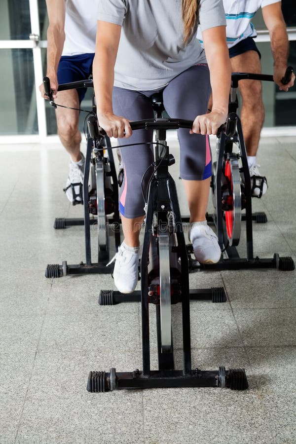 Low Section of People on Exercise Bikes Stock Image - Image of adult ...