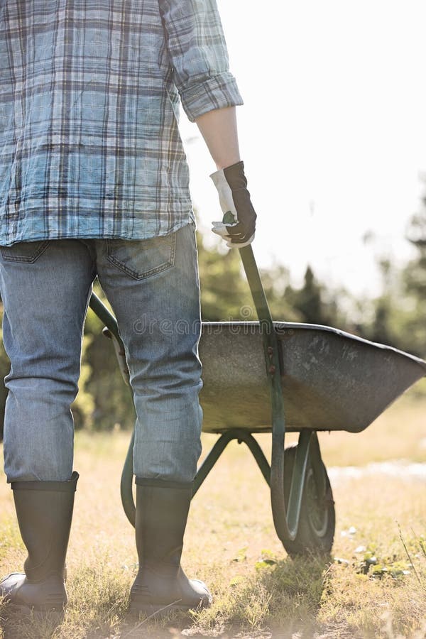 1,034 Man Pushing Wheelbarrow Stock Photos - Free & Royalty-Free Stock ...