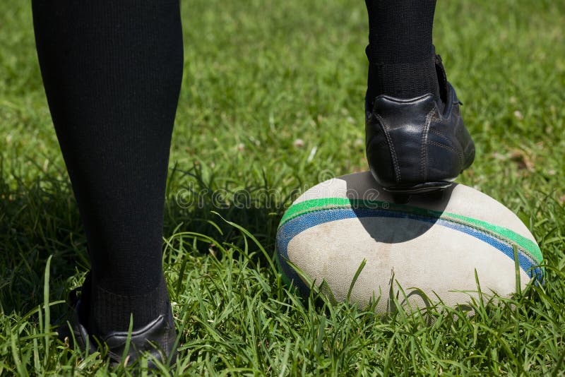 Low Section of Rugby Player with Leg on Ball Stock Image - Image of ...
