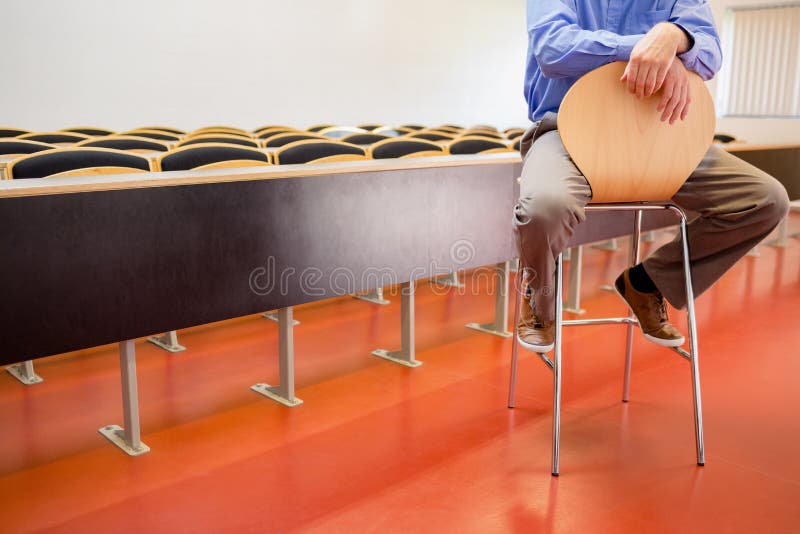 Low Section of a Teacher on Chair in Lecture Hall Stock Image - Image ...