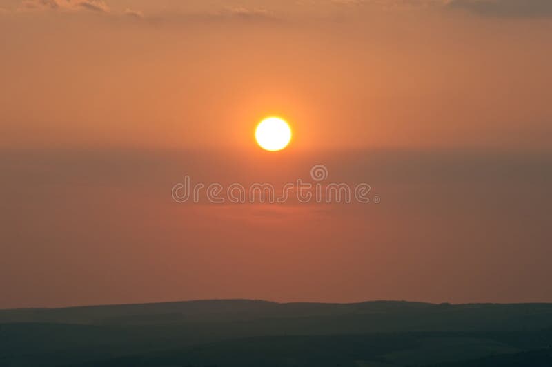 Low Setting Sun Over Distant Landscape Stock Image - Image of flare ...