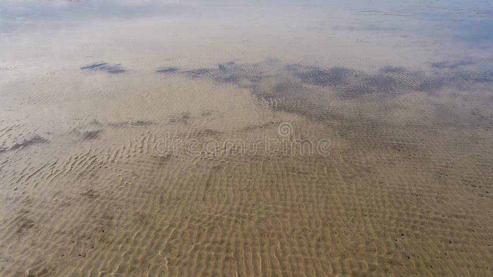 Low Tide in the Ocean. the Sandy Ridges of the Seabed are Visible ...