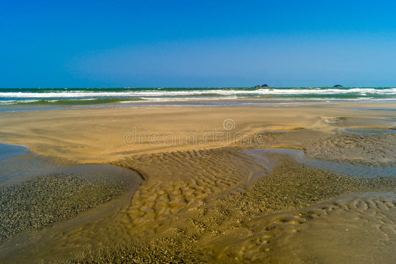 Low tide sand and water . stock photo. Image of flowing - 68524218