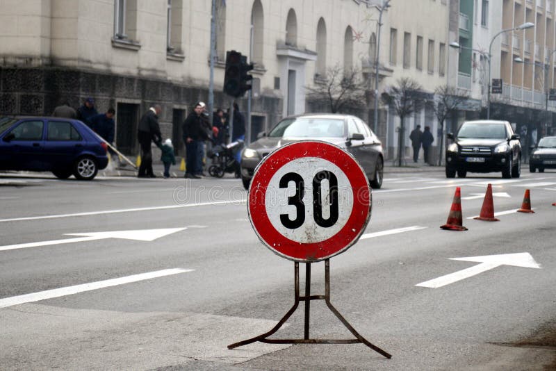 Lower Speed Traffic Sign in the Street Stock Photo - Image of black ...