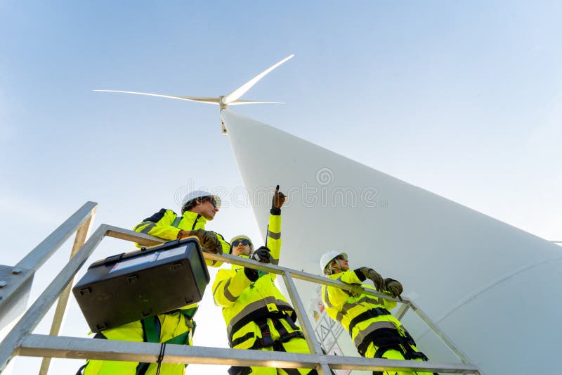 Lower View of Group of Wind Turbine or Windmill Workers or Engineers ...