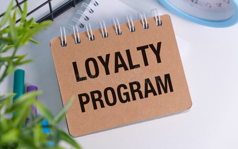 Loyalty Program Text on Blank Business Card Being Held with White Table ...