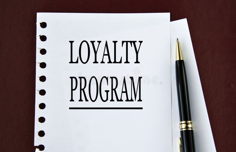 LOYALTY PROGRAM - Words on a White Sheet on a Brown Background with a ...