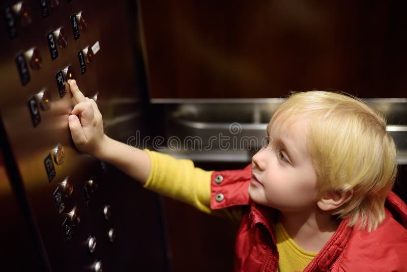 Lttle Boy Pressing Button of Lobby in Elevator Stock Photo - Image of ...