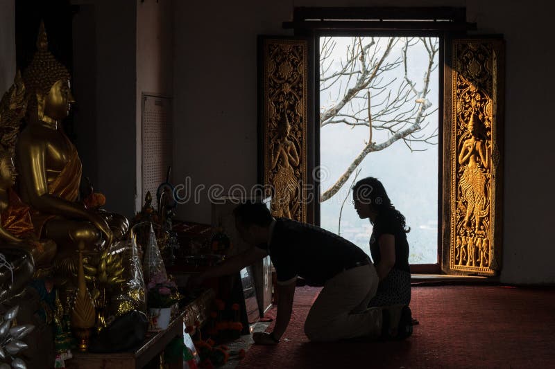 Luang Prabang, Laos - March 28, 2023: People Praying in a Temple in ...