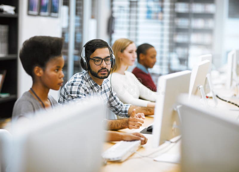 Two Focused Students on Laptop with Classmates Behind Them Stock Image ...