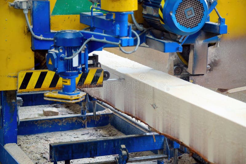 A Lumber Mill Cutting a Long Wooden Beam into Smaller Pieces during ...