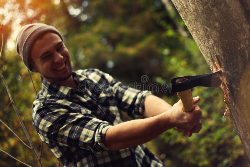 Lumberjack Chopping Wood. Young Man Chopping Woods with an Axe Stock ...