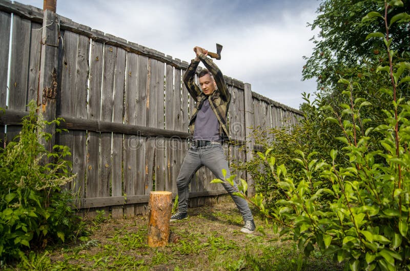 Lumberjack Chopping Wood. Young Man Chopping Woods with an Axe Stock ...